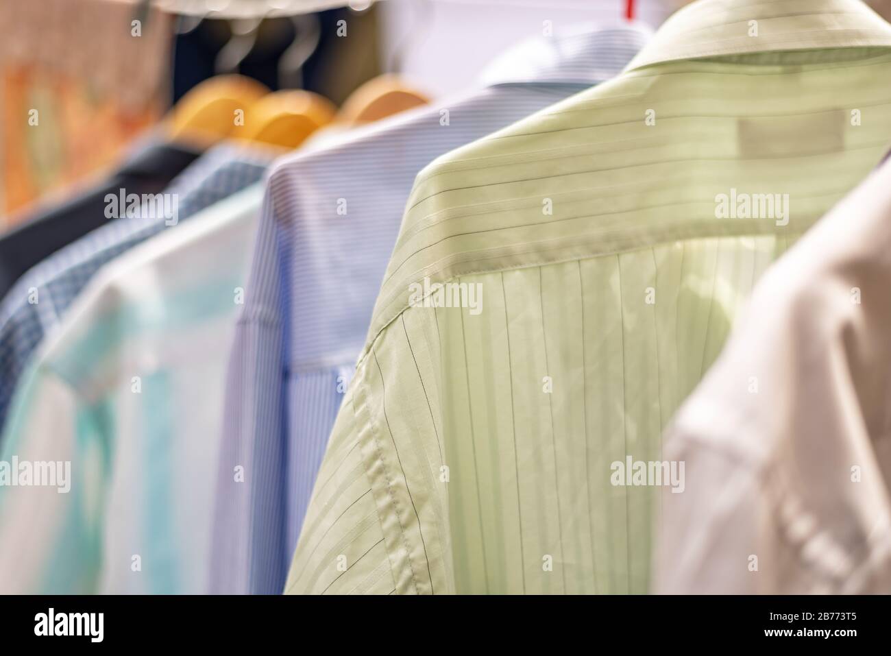 Bunch of shirts hanged in line on clothes hanger Stock Photo - Alamy