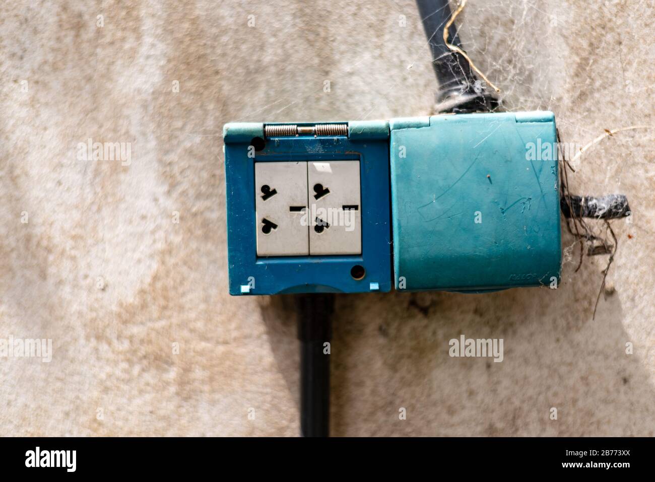 Old power line plug on a concrete wall with some spider webs Stock ...