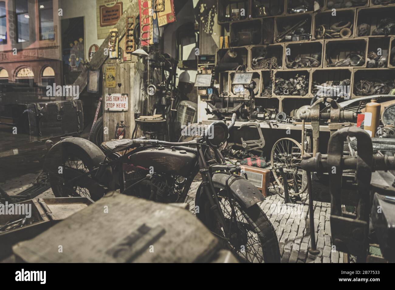 Old dark auto repair shop with wheels and spare parts Stock Photo - Alamy