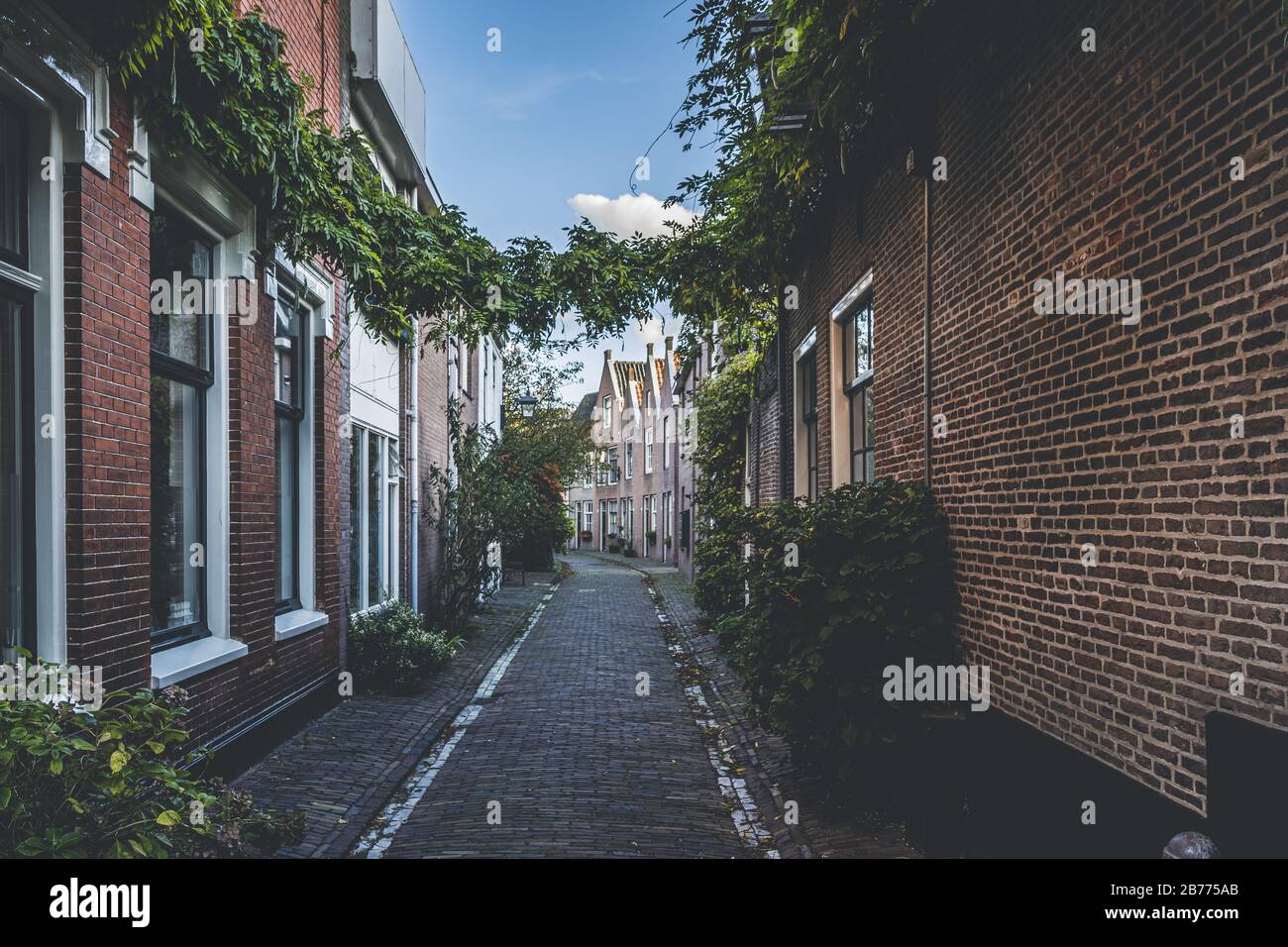 Narrow route through brick buildings during daytime Stock Photo - Alamy