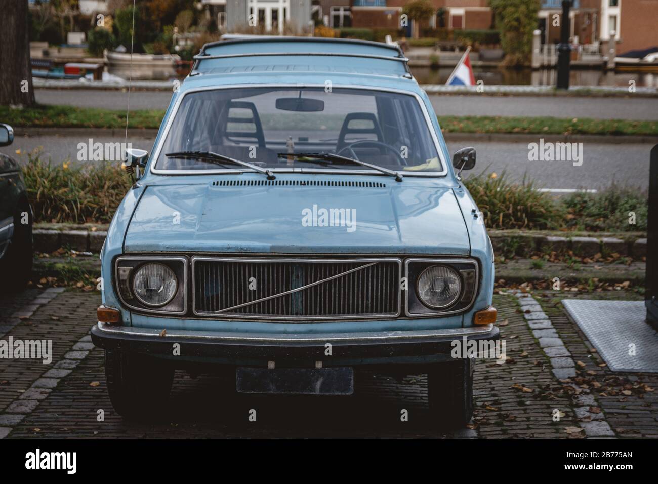 Old sky-blue car parked in the street Stock Photo - Alamy