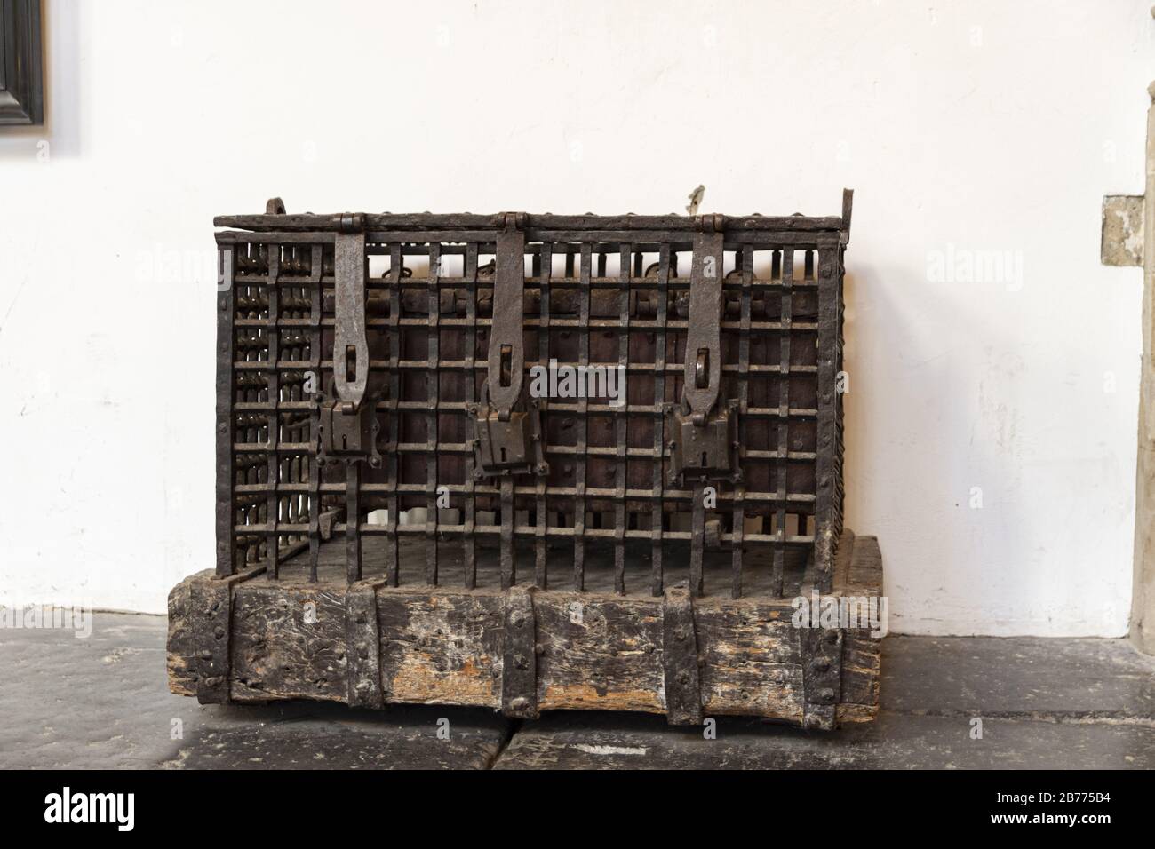 Metal cell with three locks near a white wall Stock Photo - Alamy