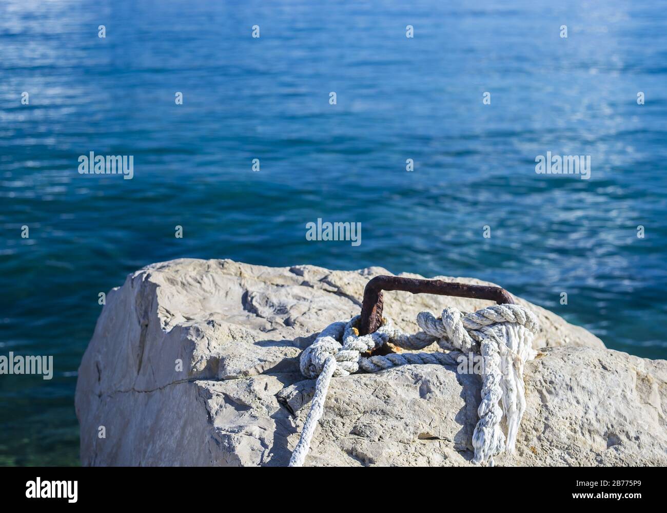 Selective focus shot of a bent metal protruding in the cement with a ...