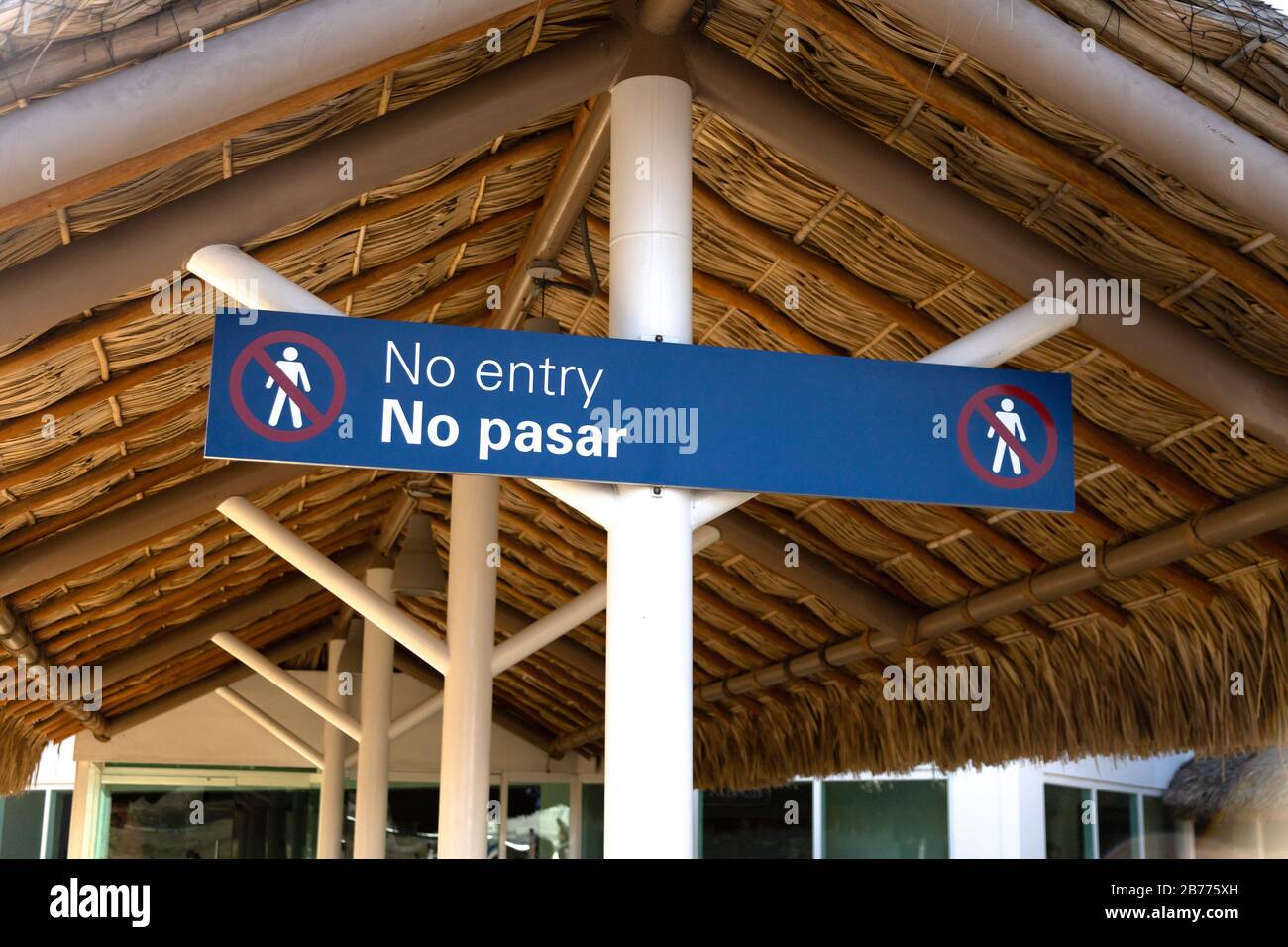 Blue sign with no pasar - no entry - text written on it under the ...