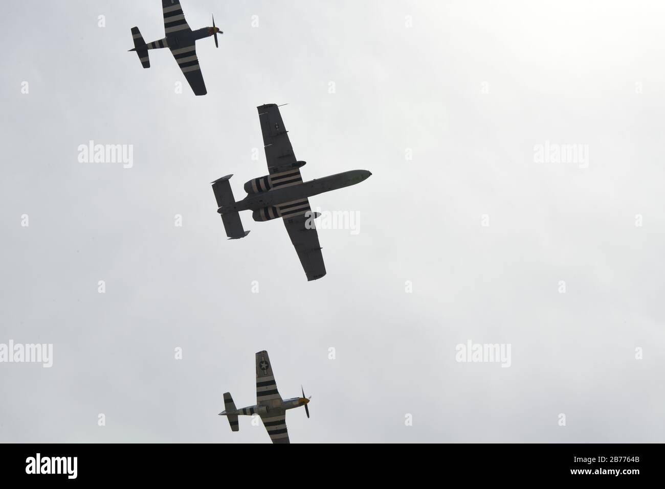 An A-10 Thunderbolt II flies next to two heritage aircraft during the ...