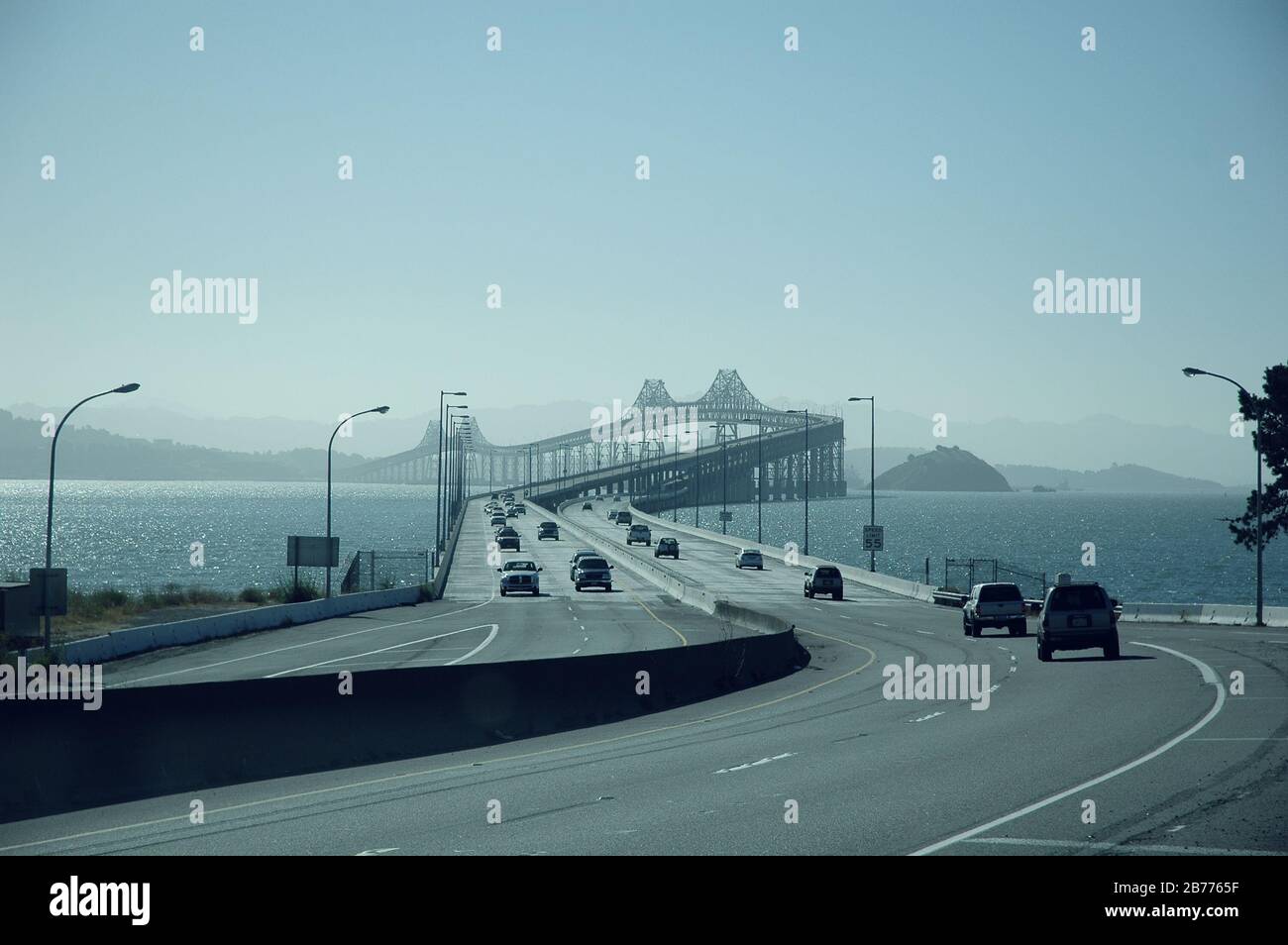 Cars riding through The Richmond–San Rafael Bridge surrounded by the ...