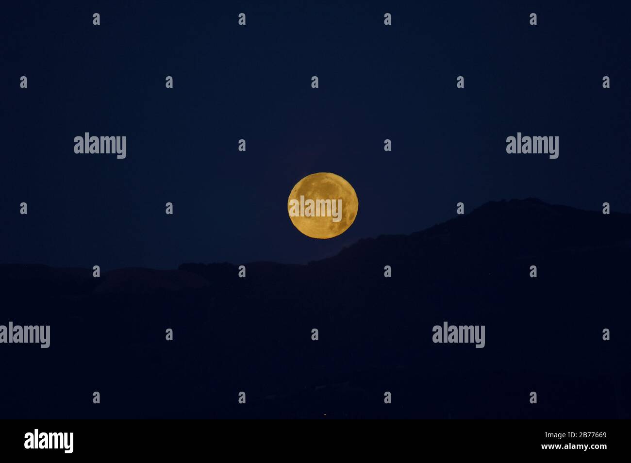 Yellow full moon above the hills in the night - great for backgrounds ...
