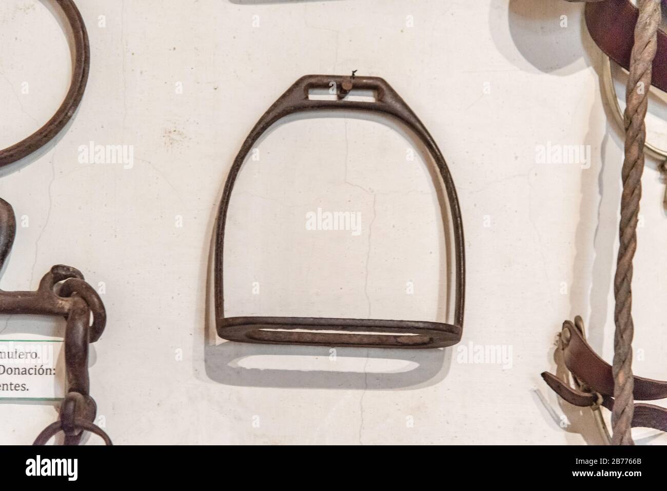 Metal stirrup hanging on a white wall Stock Photo - Alamy