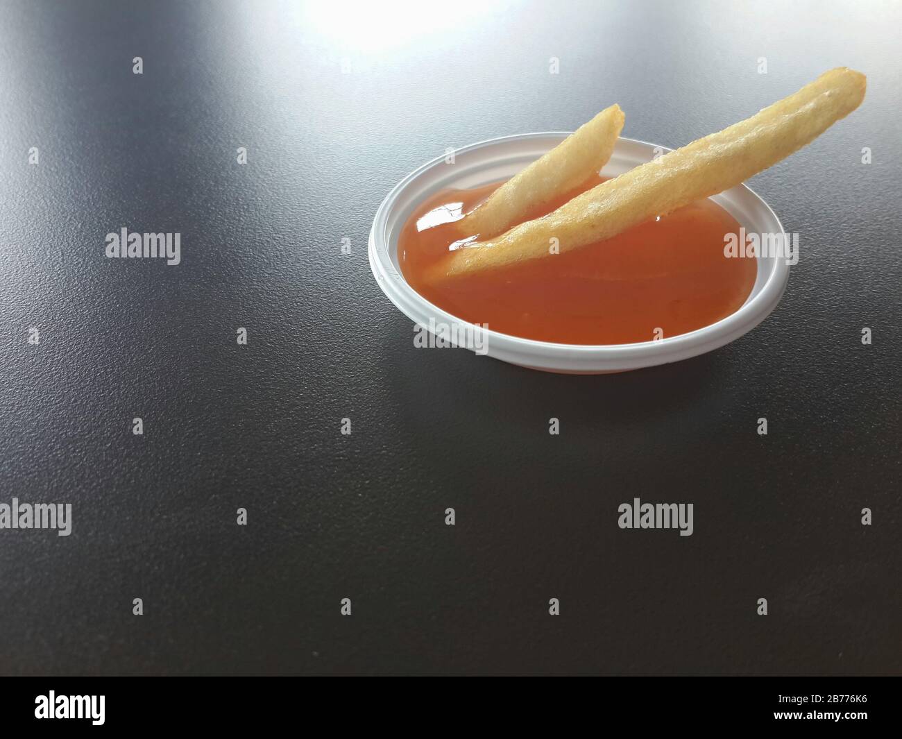 sauce french fries, french fries in chili sauce cup Stock Photo - Alamy