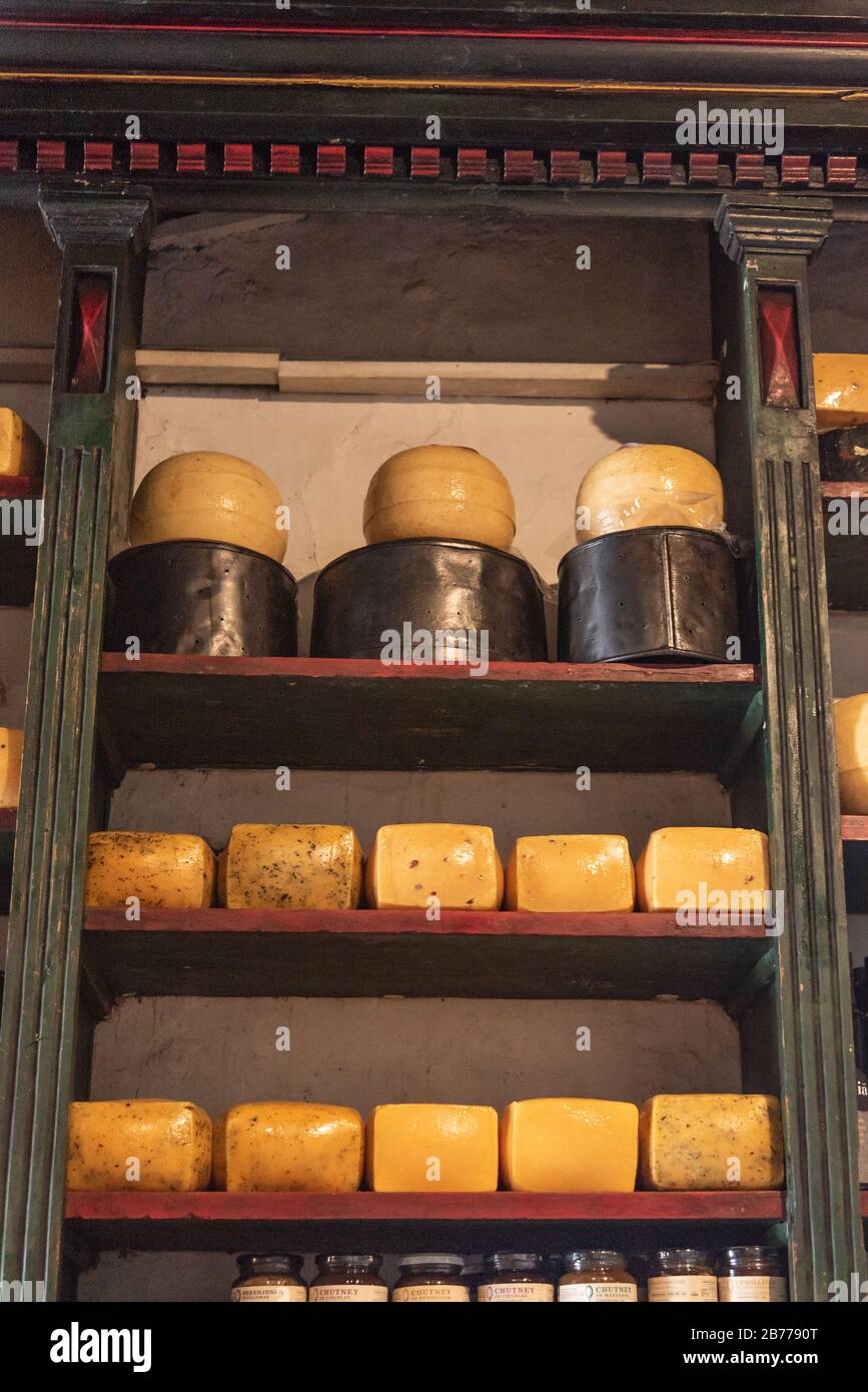 Cheese stacked and accommodated on an old wooden shelf Stock Photo - Alamy