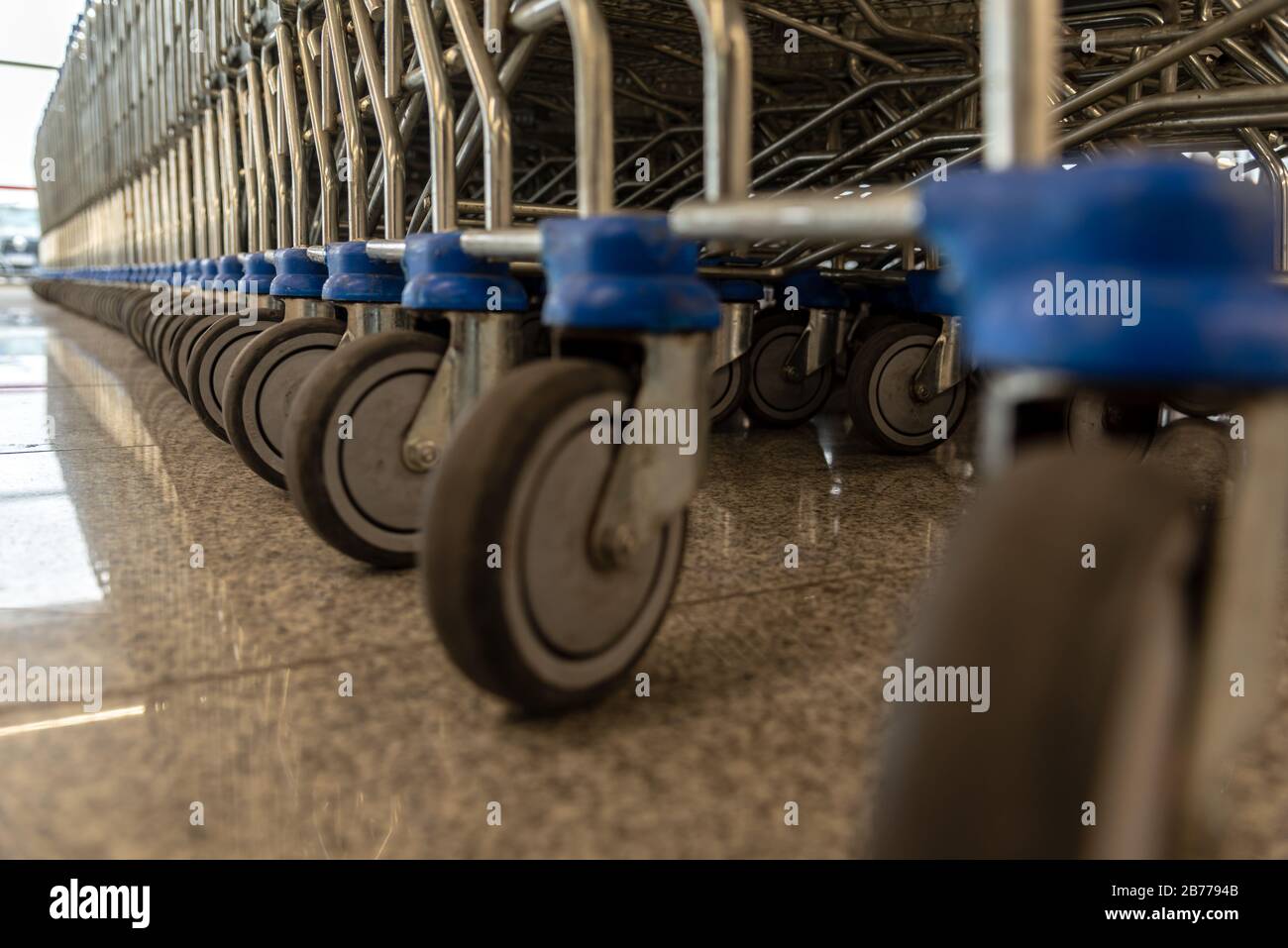 Detail of lot of supermarket carts wheels with blue plastic Stock Photo ...