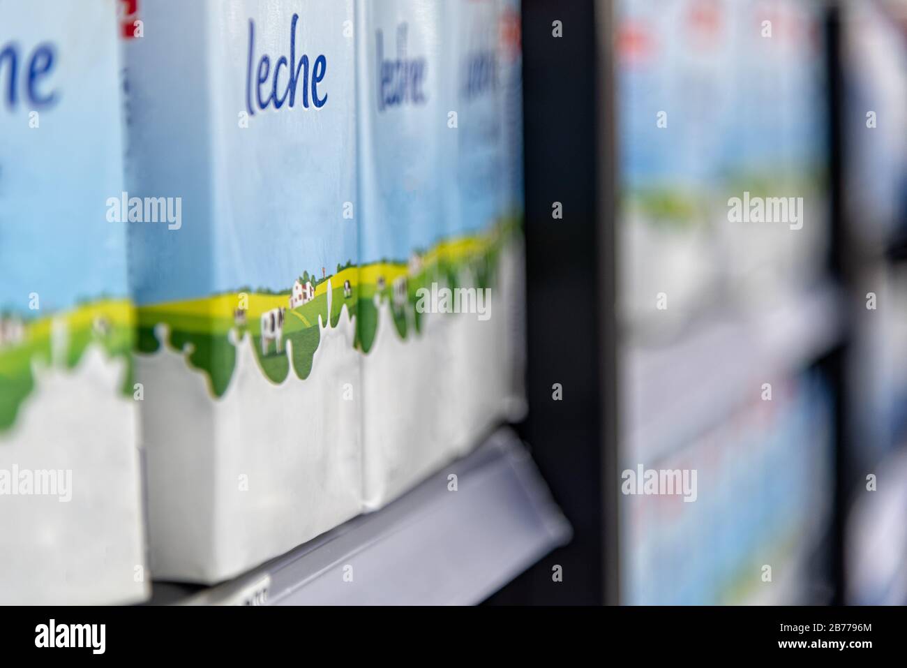 Milk cartons on a sale shelf with the word "milk" in spanish (leche ...