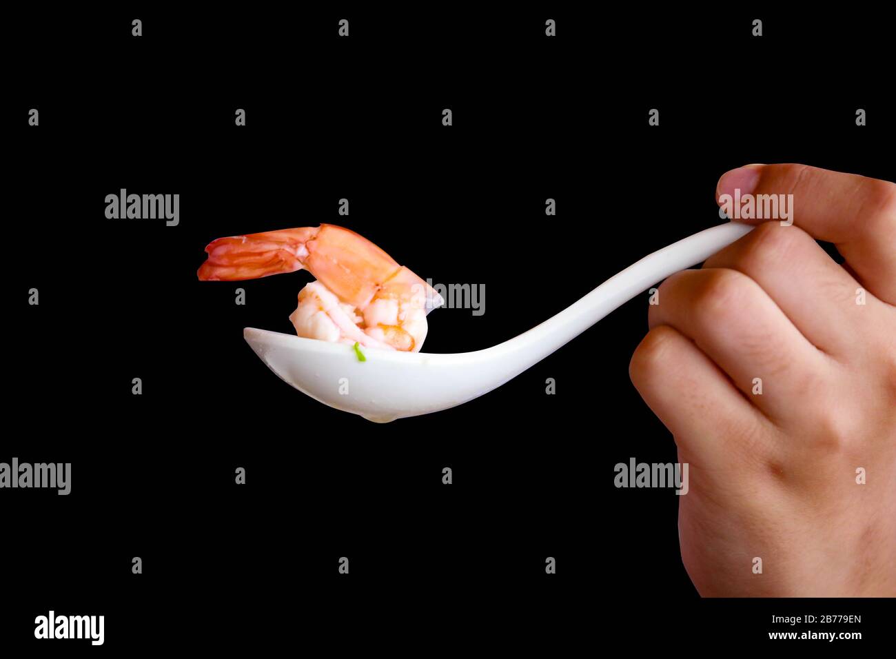 Shrimp in a spoon isolated on black background.This had clipping path ...