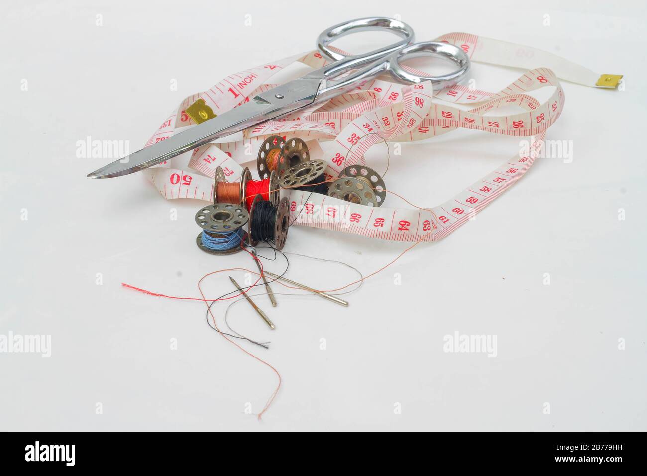 Sewing equipment, tape measure, thread, scissors Stock Photo - Alamy