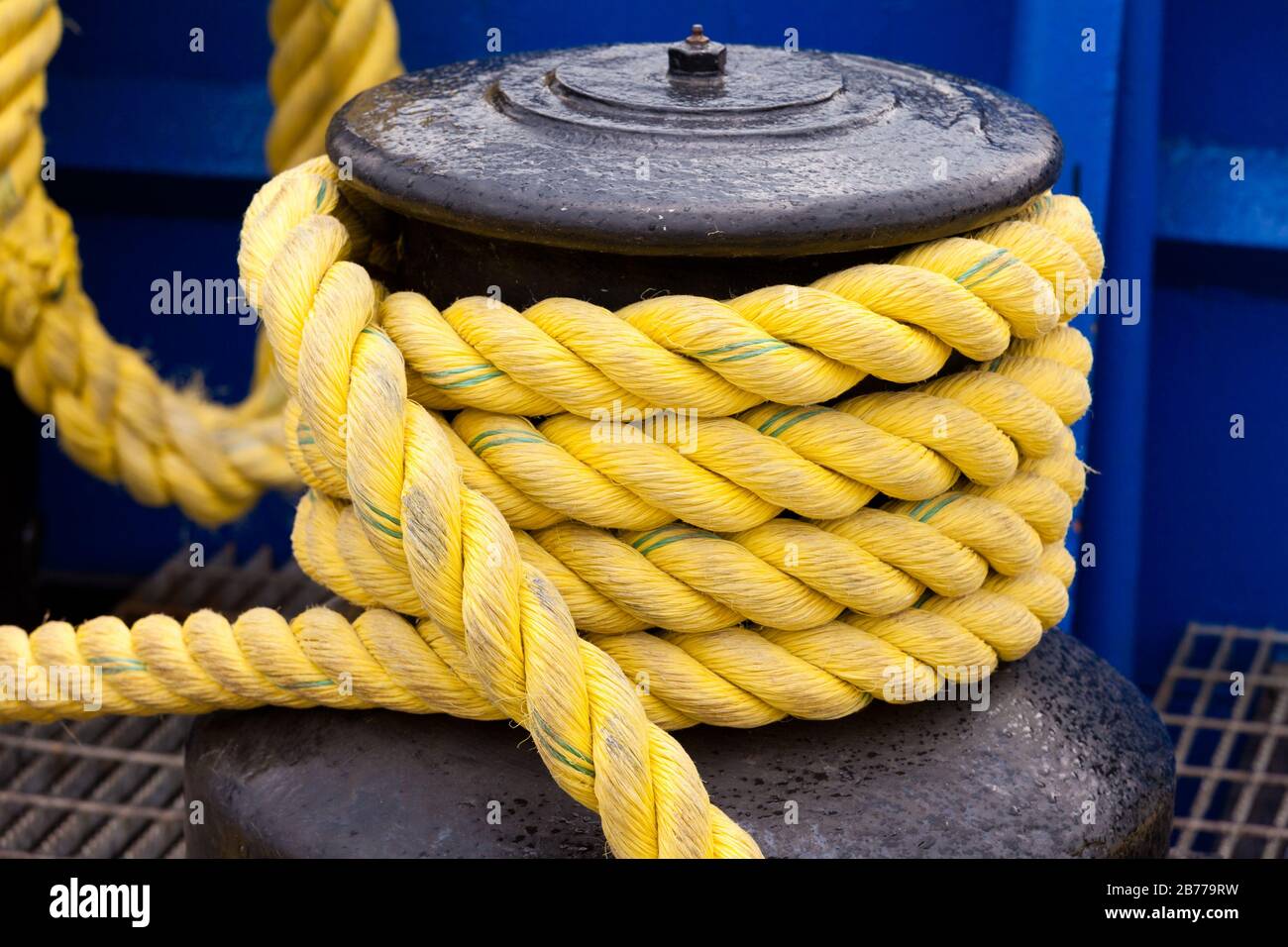 Closeup shot of a thick yellow rope tied on a metal stand Stock Photo ...