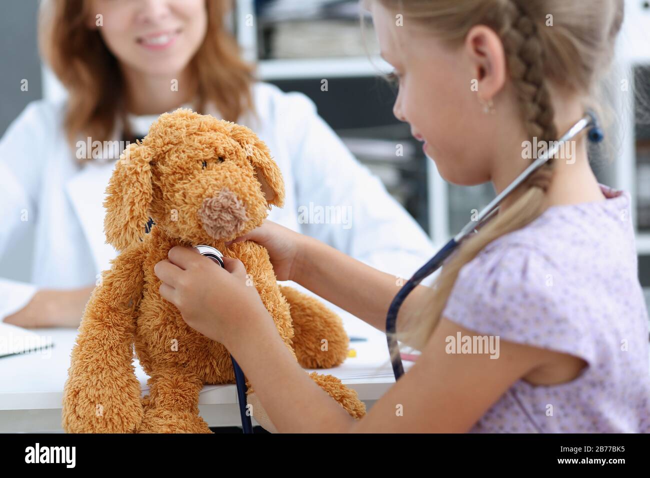 Little child with stethoscope at doctor reception Stock Photo - Alamy