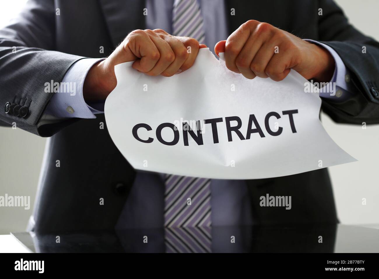 White collar worker in suit and tie tear contract Stock Photo - Alamy