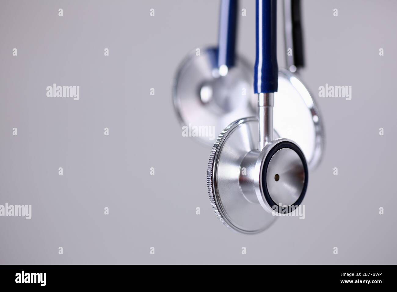 Stethoscope head lying on gray background closeup Stock Photo - Alamy
