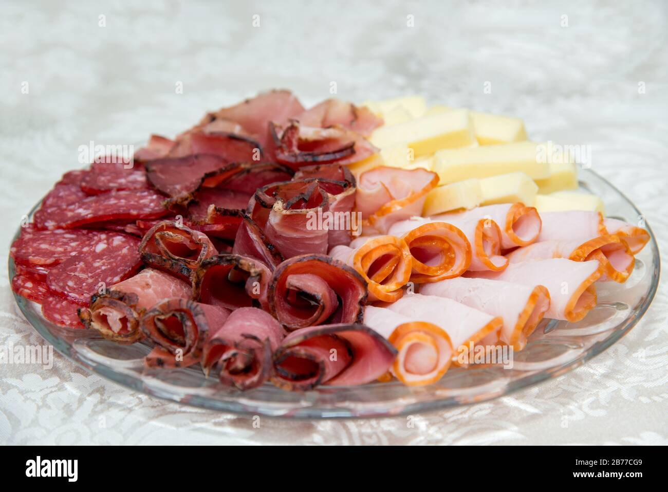 Different types delicacies of meat and cheese arranged in a plate over ...