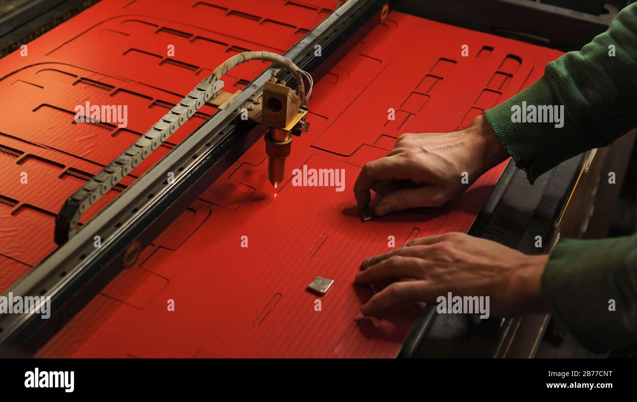 Laser cutting beam high precision on a paperboard. Modern machine ...