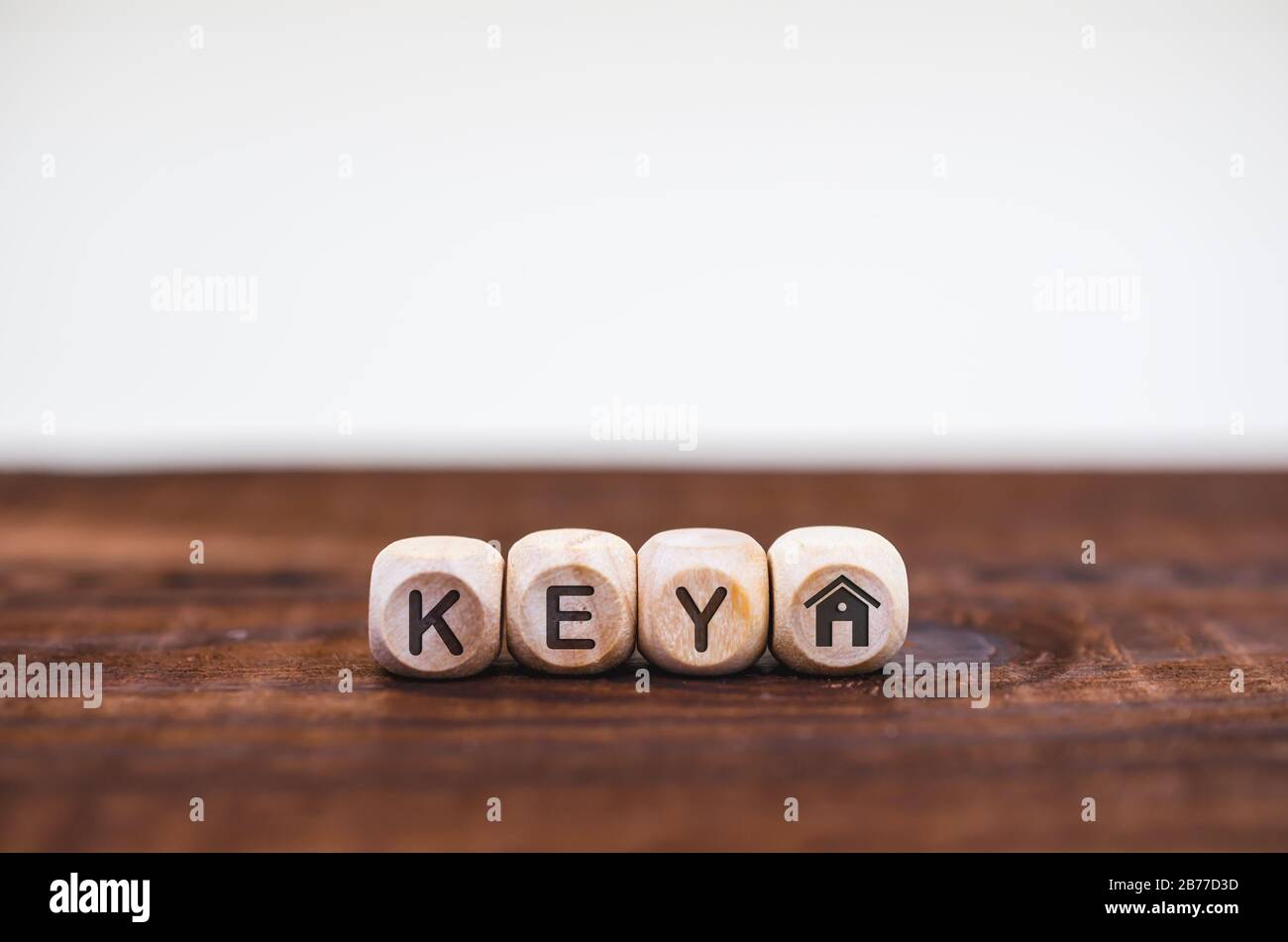 Wood cube blocks with icon house and word KEY. Property investment and ...