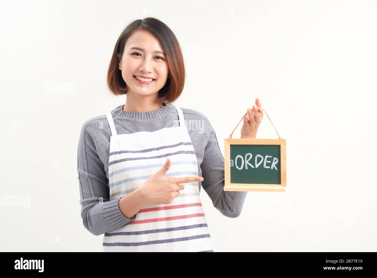 Portrait of waitress showing chalkboard with order sign on white Stock ...