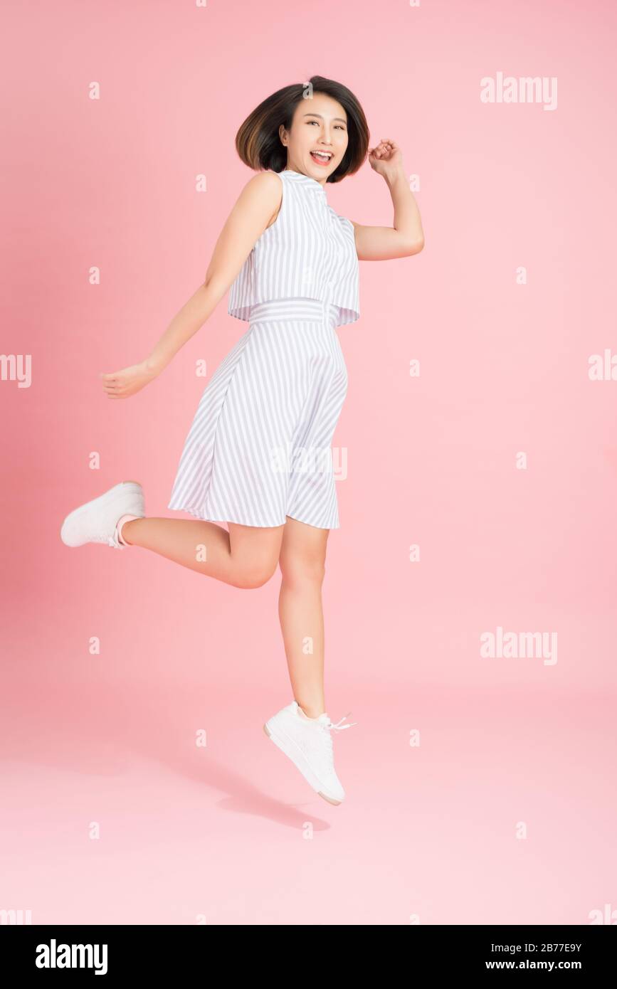 Freedom in moving. Surprised, pretty, happy young woman jumping and ...