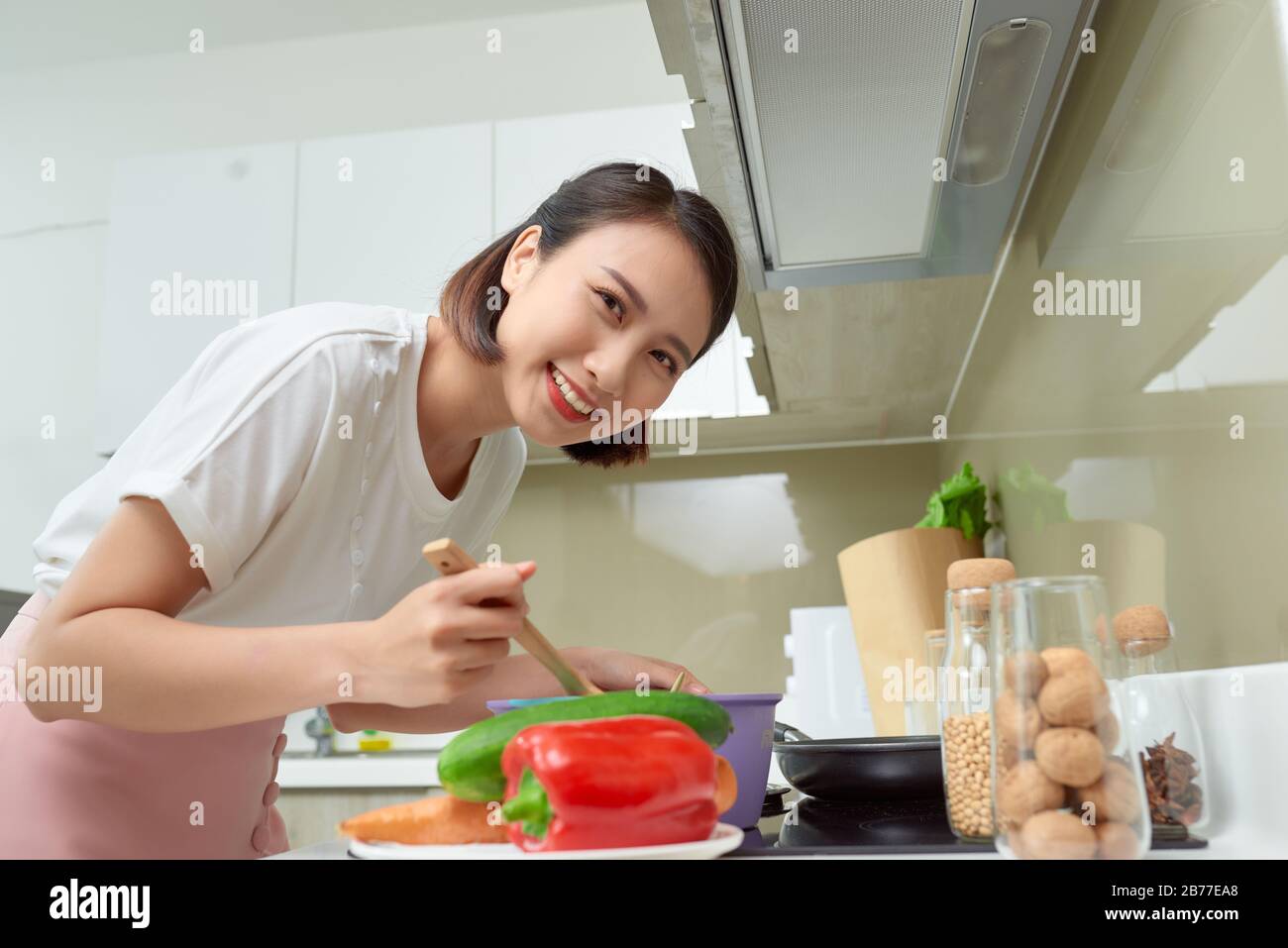 Young Woman Cooking in the kitchen. Healthy Food. Dieting Concept ...