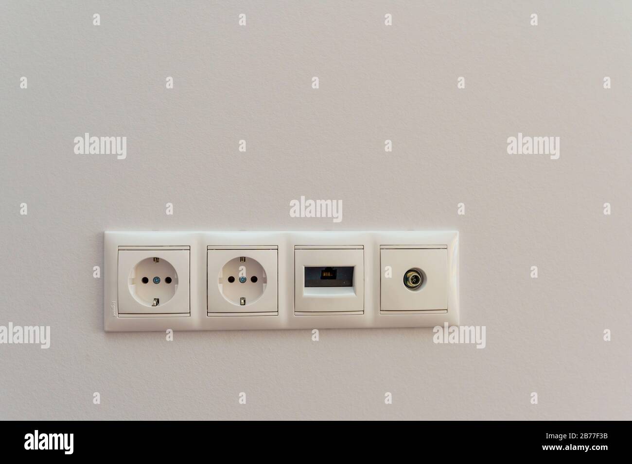 Electrical outlets, connectors for Internet and cable TV on the wall in ...