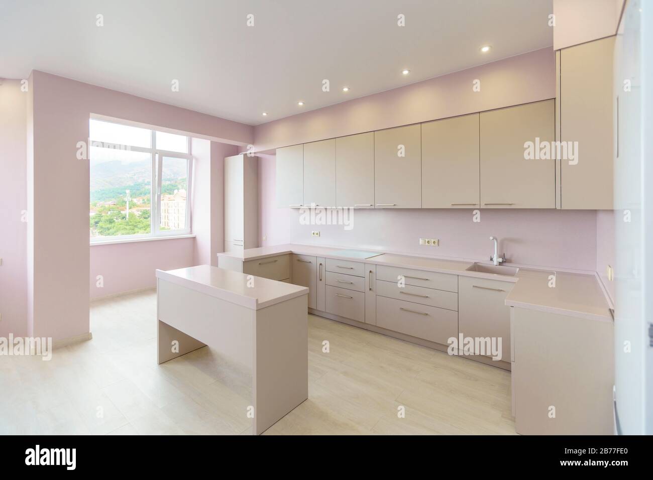 Minimalistic new milk- colored kitchen in a new building. Kitchen set ...