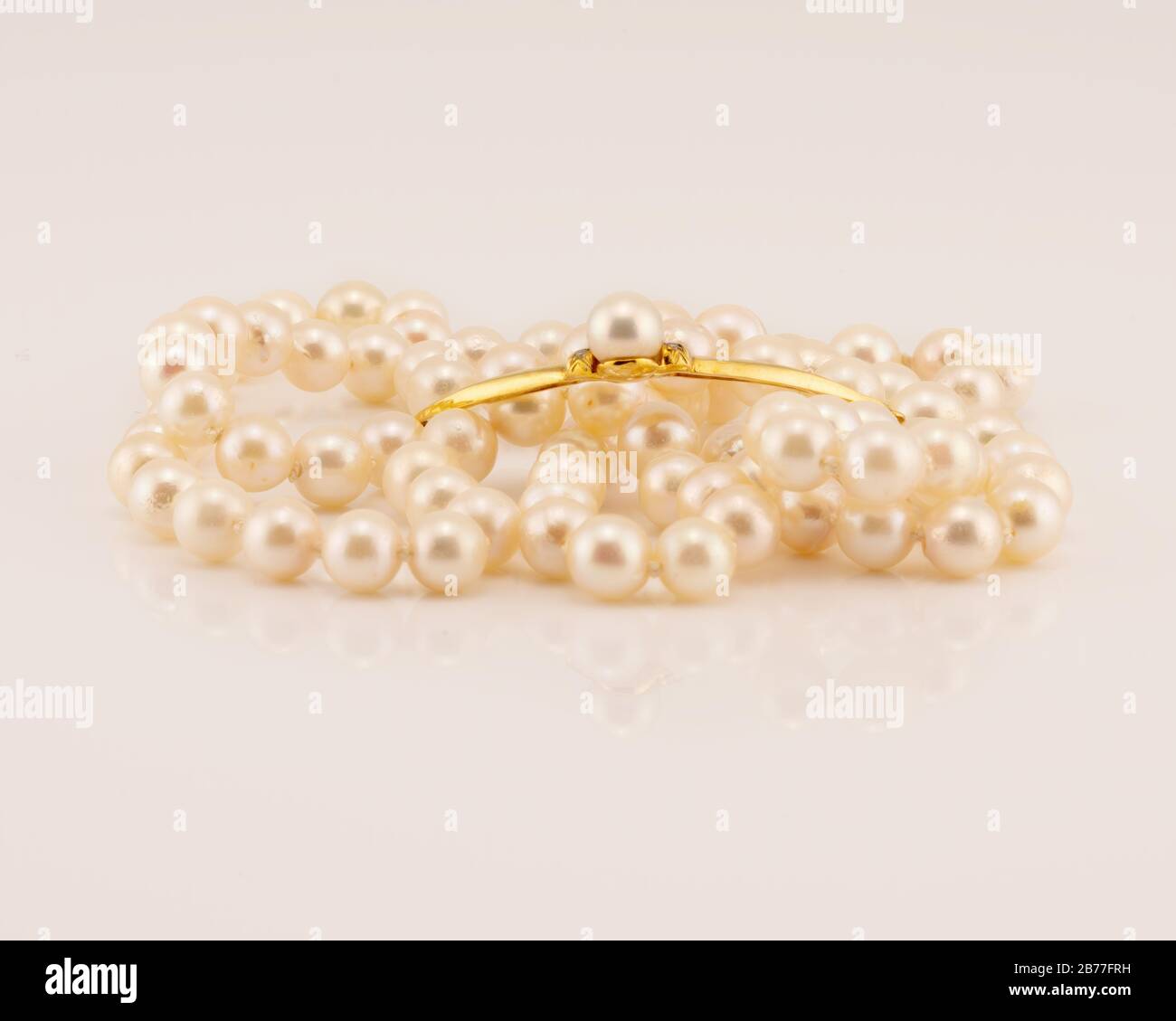 A string of lustrously glowing natural pearls designed as a necklace ...