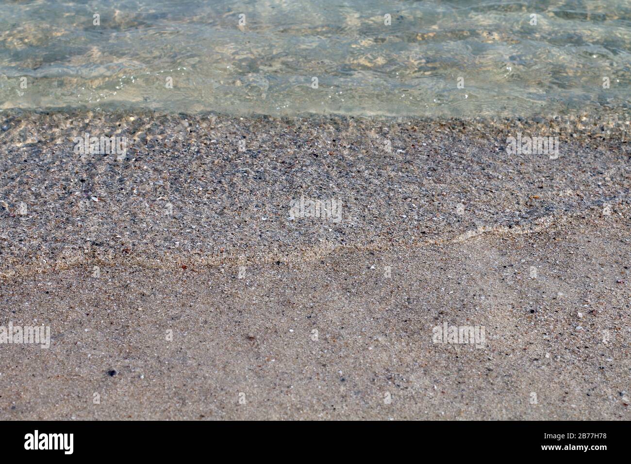 Surface water wave on the sand close up, Wave of the sea on the sand ...