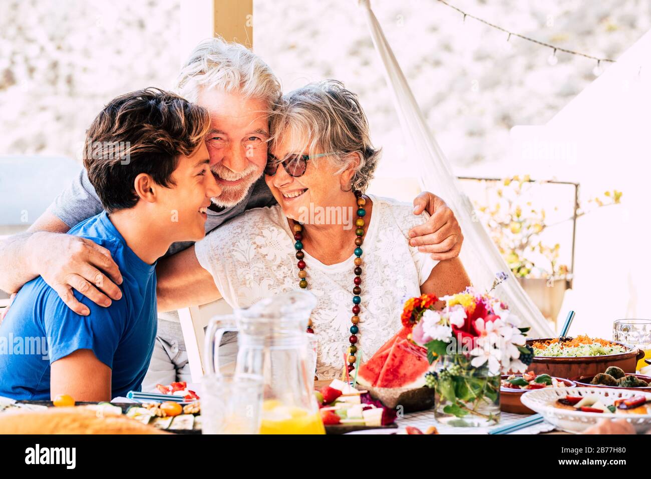 Happy family with grandfathers and grandson together hugging and smilng ...