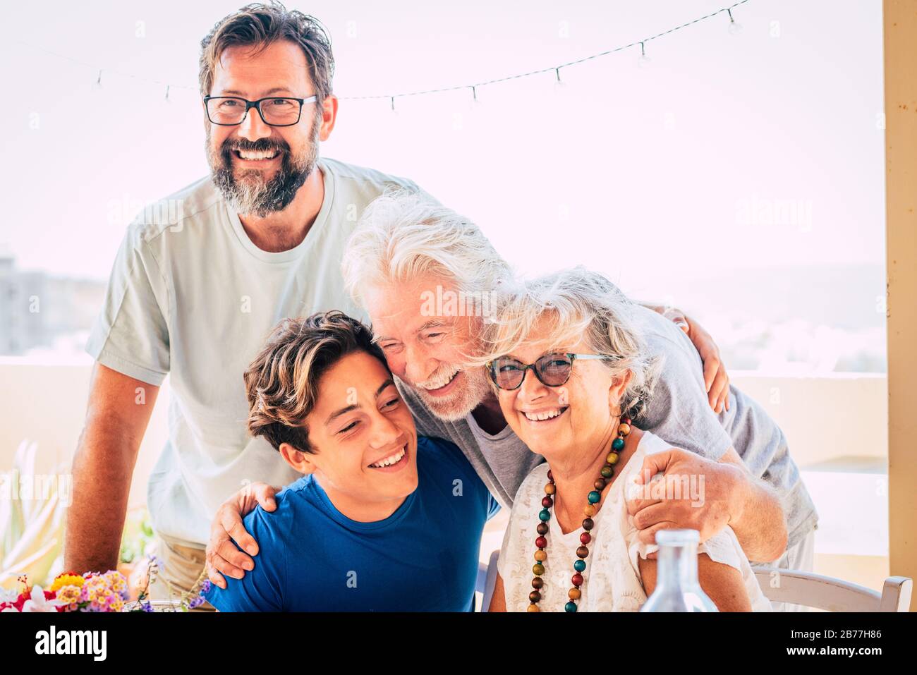 Happy mixed three generations family hug and enjoy together - people ...