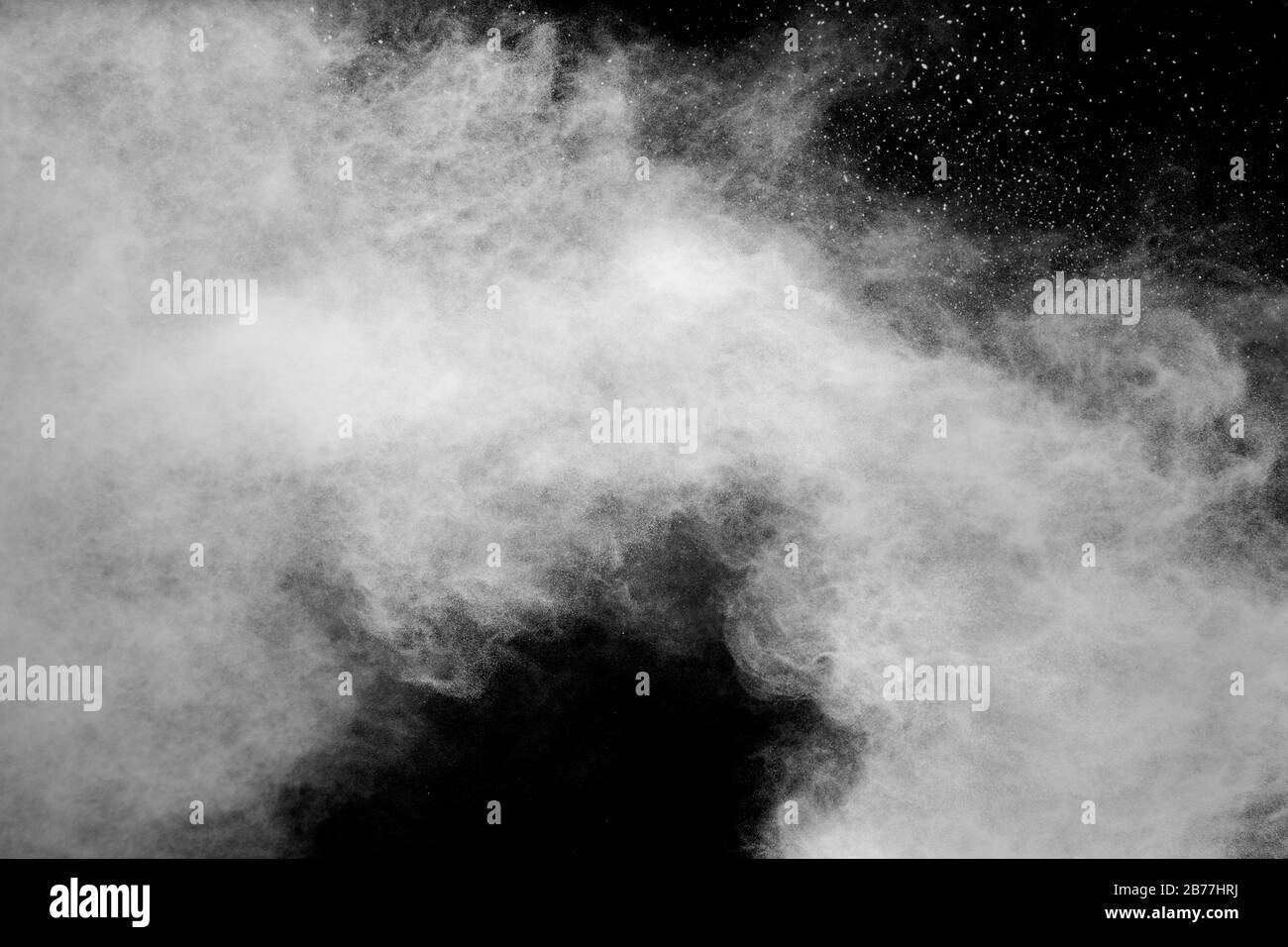 Freeze motion of white dust particles splash on black background.White ...