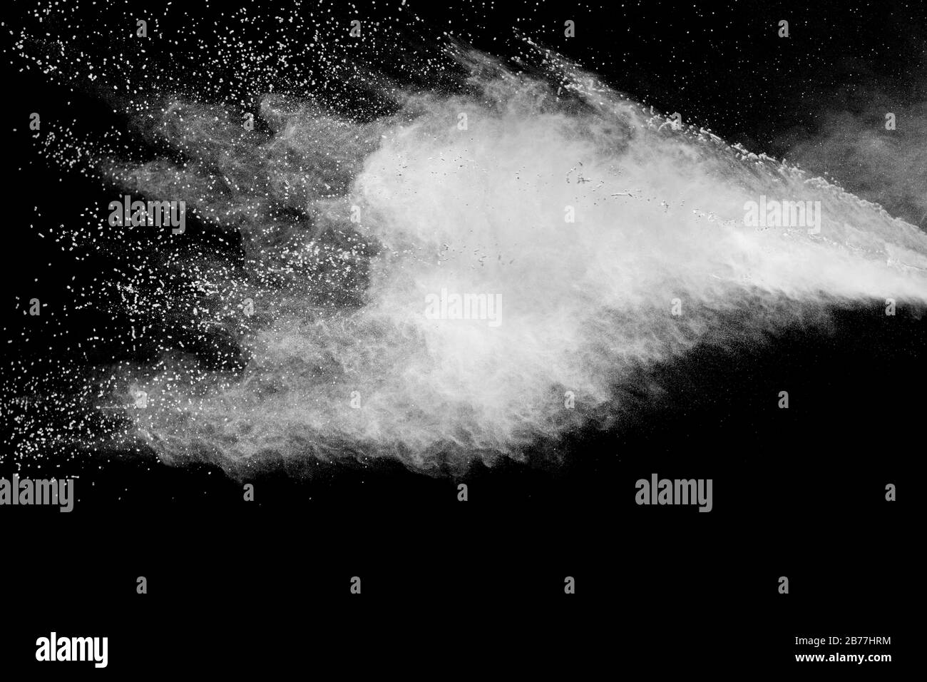 Freeze motion of white dust particles splash on black background.White ...