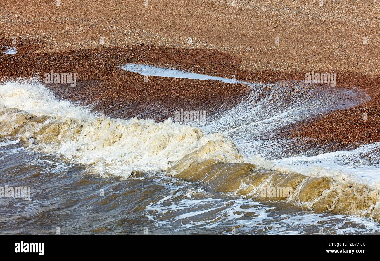 Waves breaking onto a shingle beach Stock Photo - Alamy