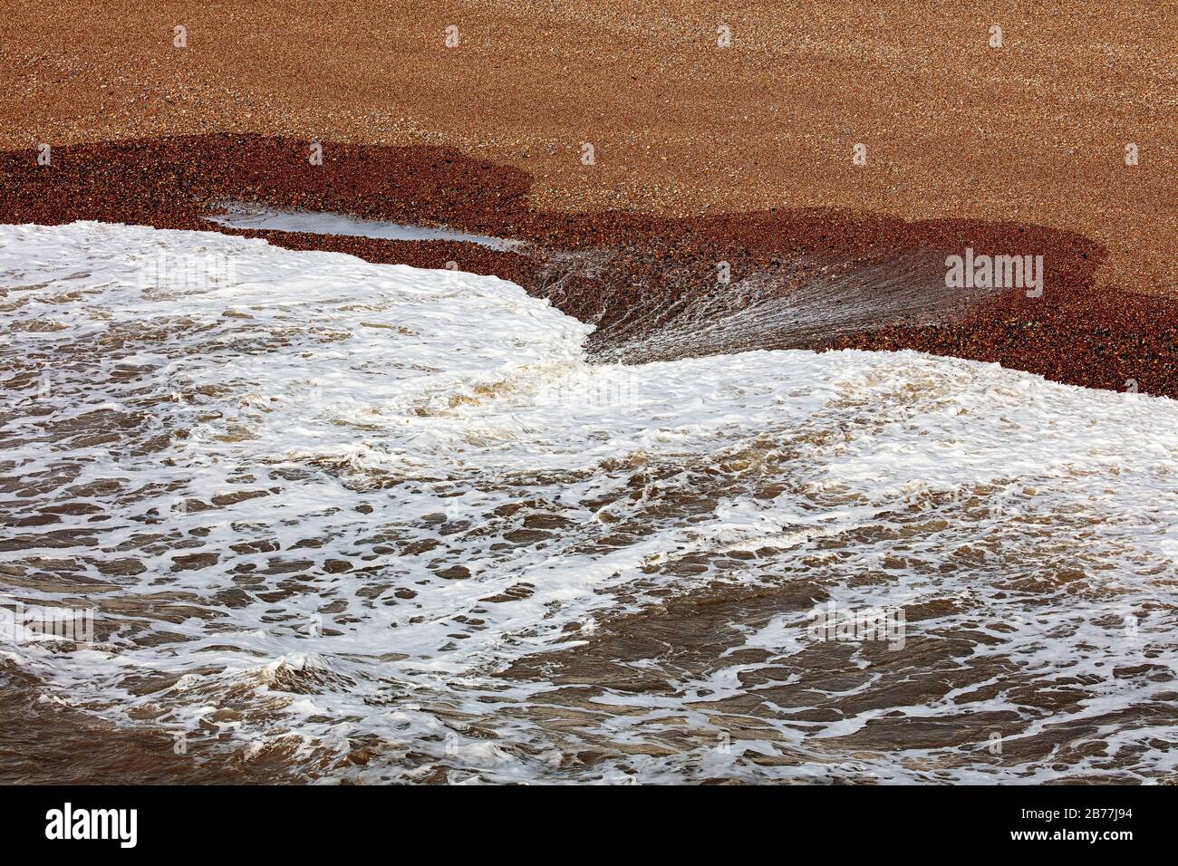 Waves breaking onto a shingle beach Stock Photo - Alamy