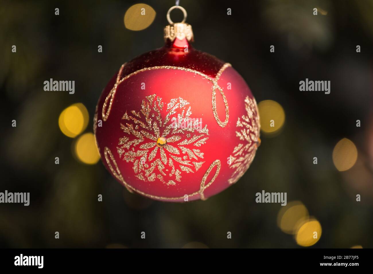 Detail of a traditional Christmas flask hanging on a tree in front of ...