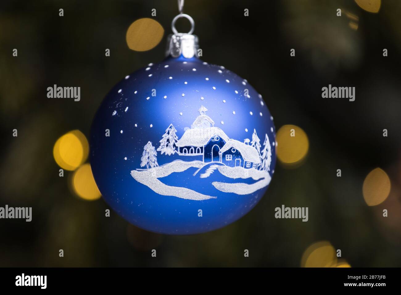 Detail of a traditional Christmas flask hanging on a tree in front of ...