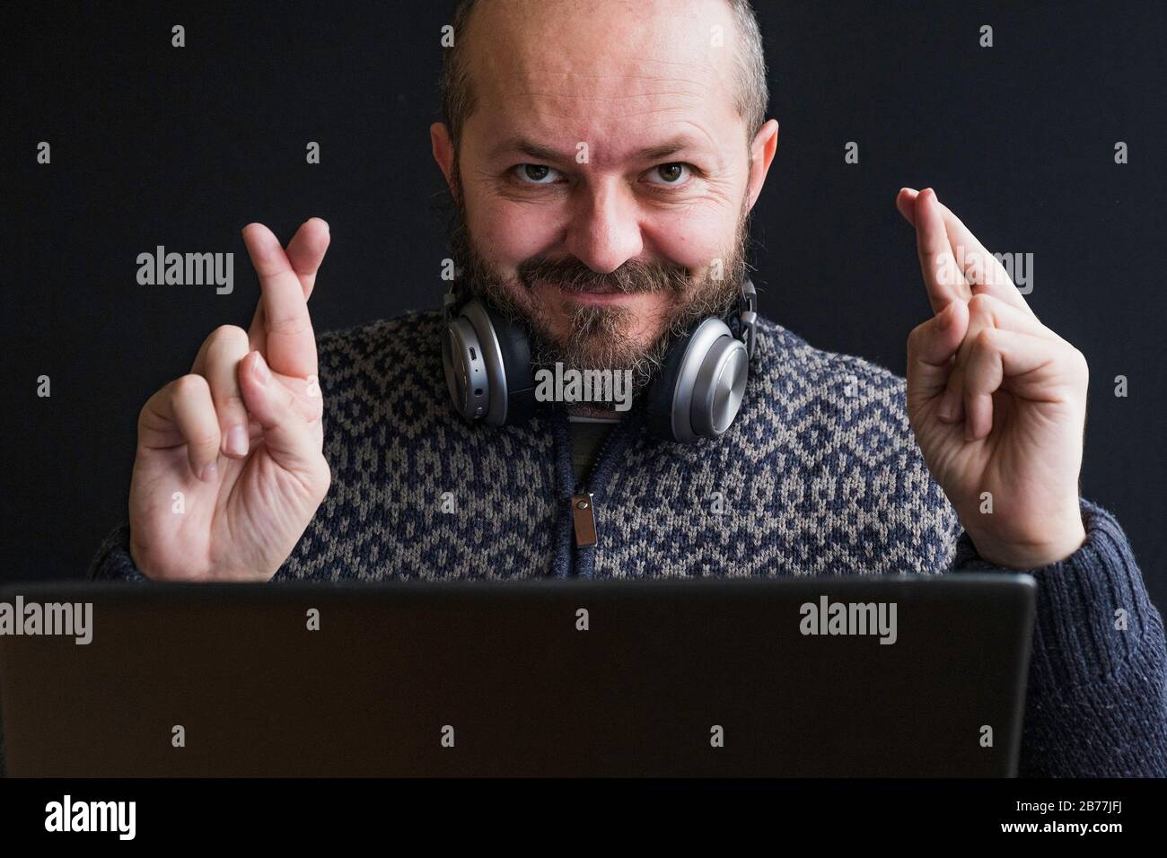 Caucasian adult man in vintage sweater and headphones around neck ...