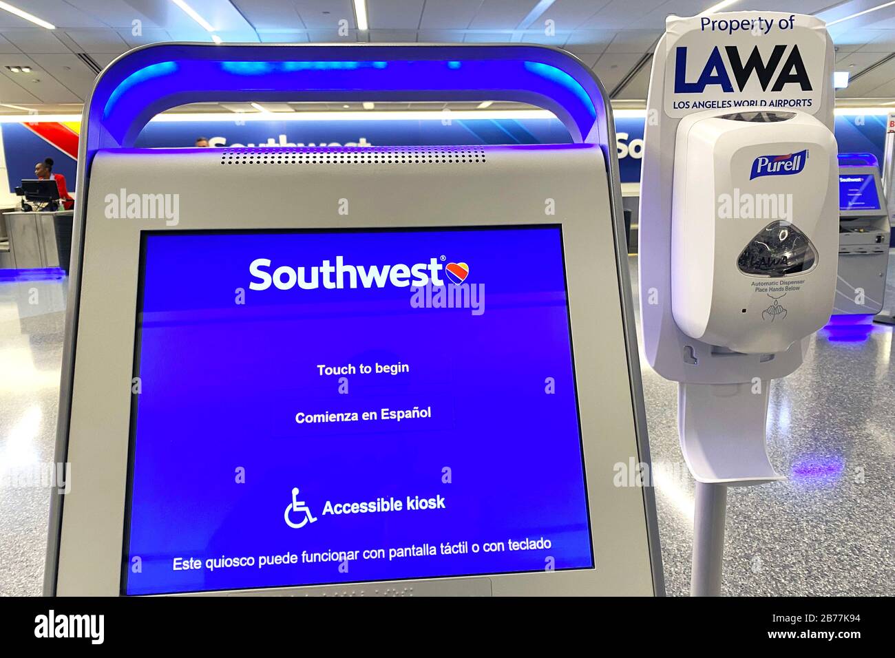 A hand sanitizer station at a Southwest Airlines check-in kiosk at ...
