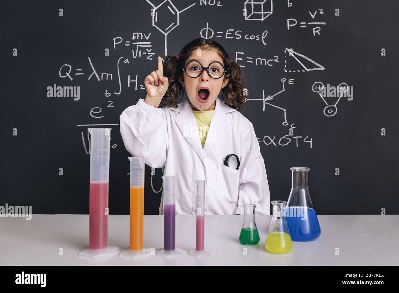 surprised scientist child with glasses in lab coat with chemical flasks ...