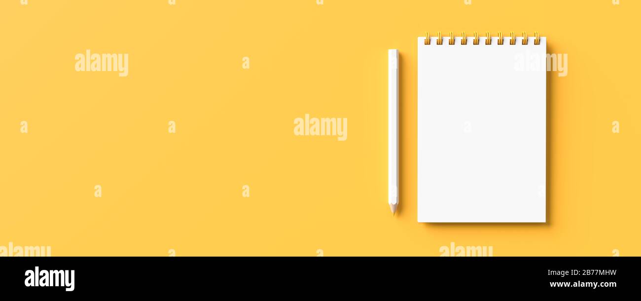 White pencil and notebook isolated on yellow background with copy space ...