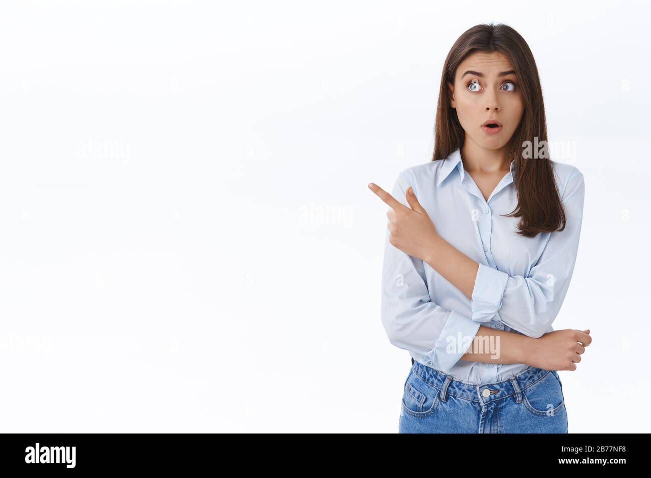 Surprised wondered brunette girl seeing something intriguing and ...