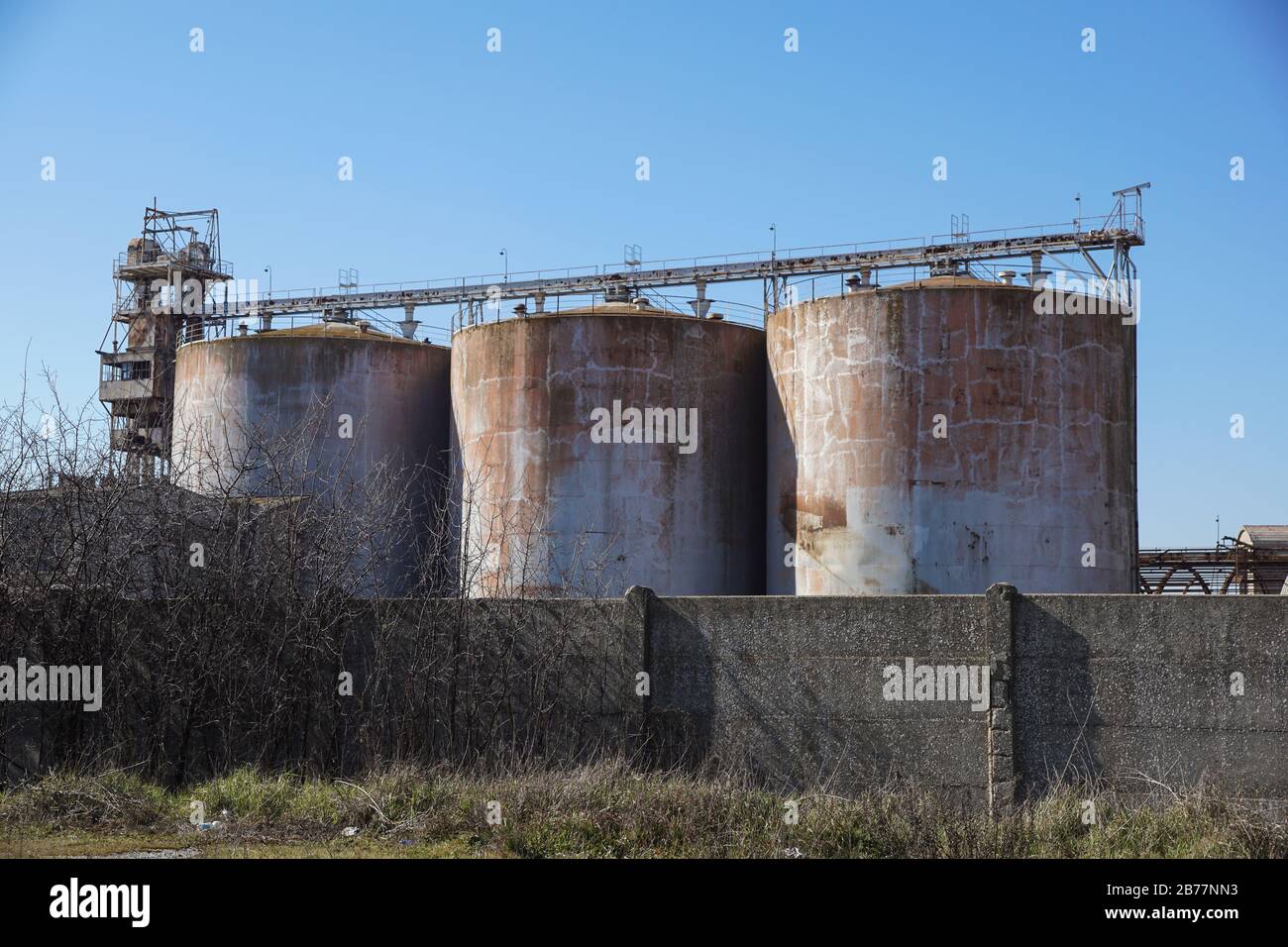old abandoned cement silo with blue sky background Stock Photo - Alamy