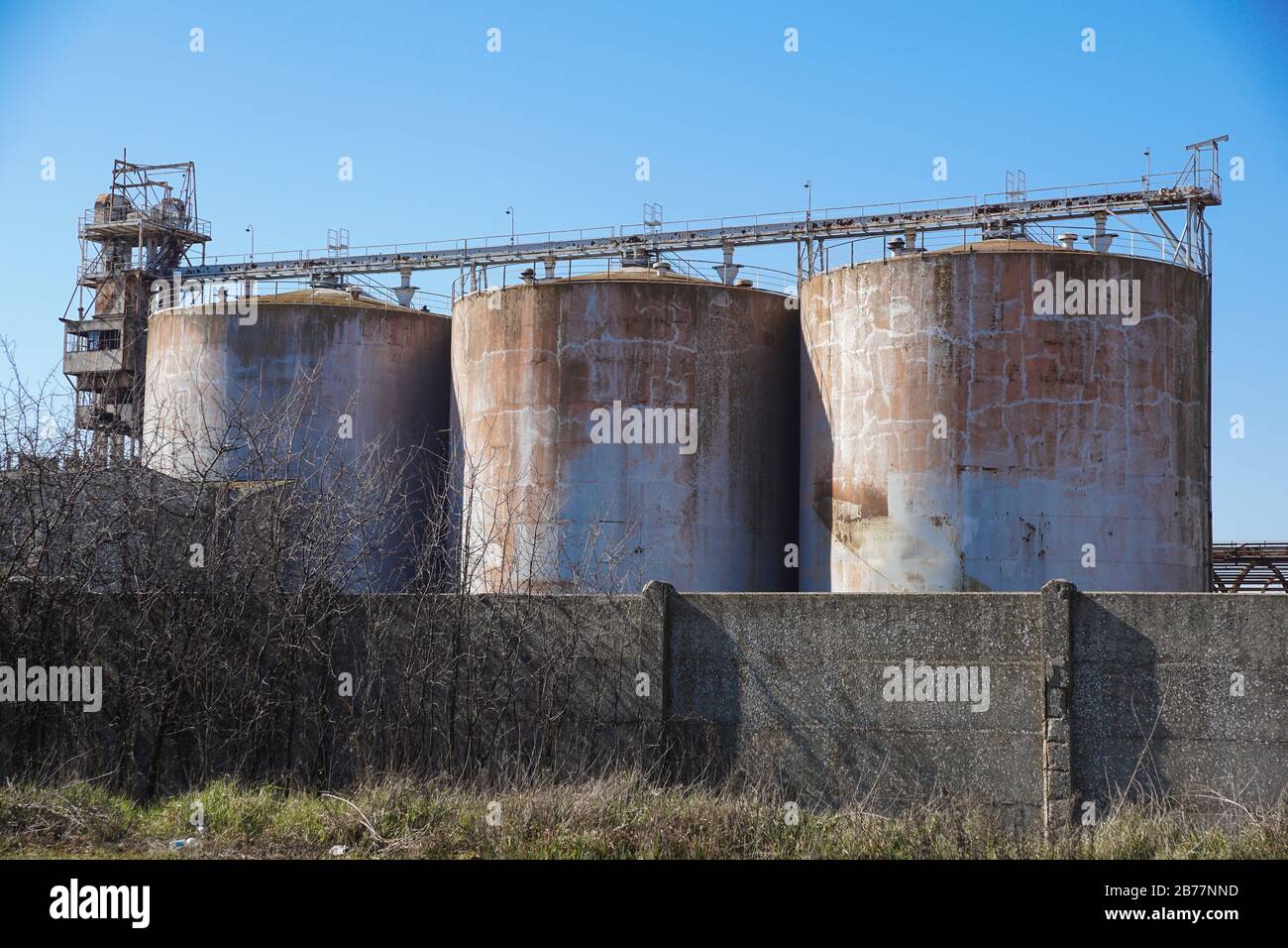 old abandoned cement silo with blue sky background Stock Photo - Alamy