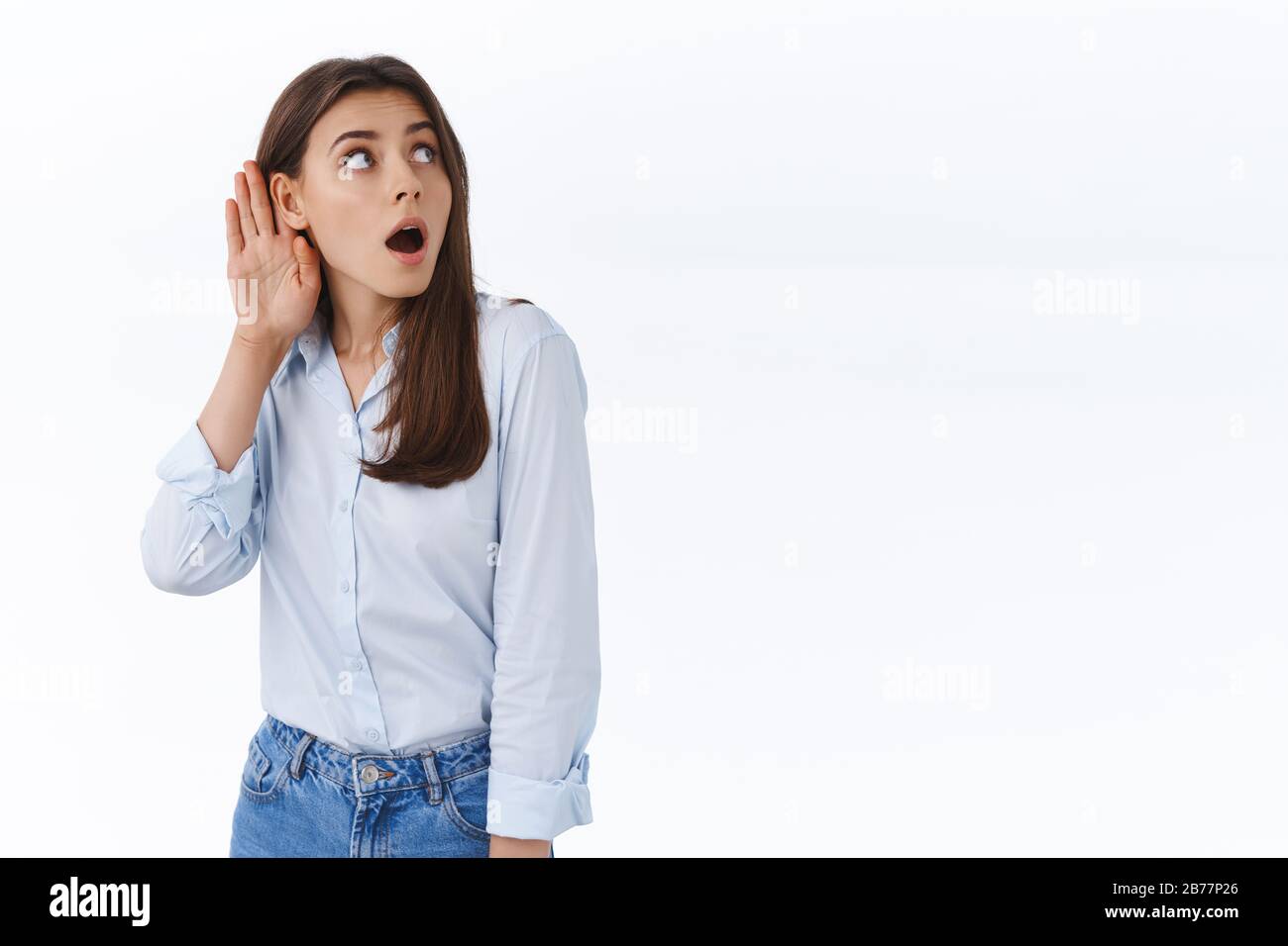 Intrigued and curious female office worker overhear interesting ...