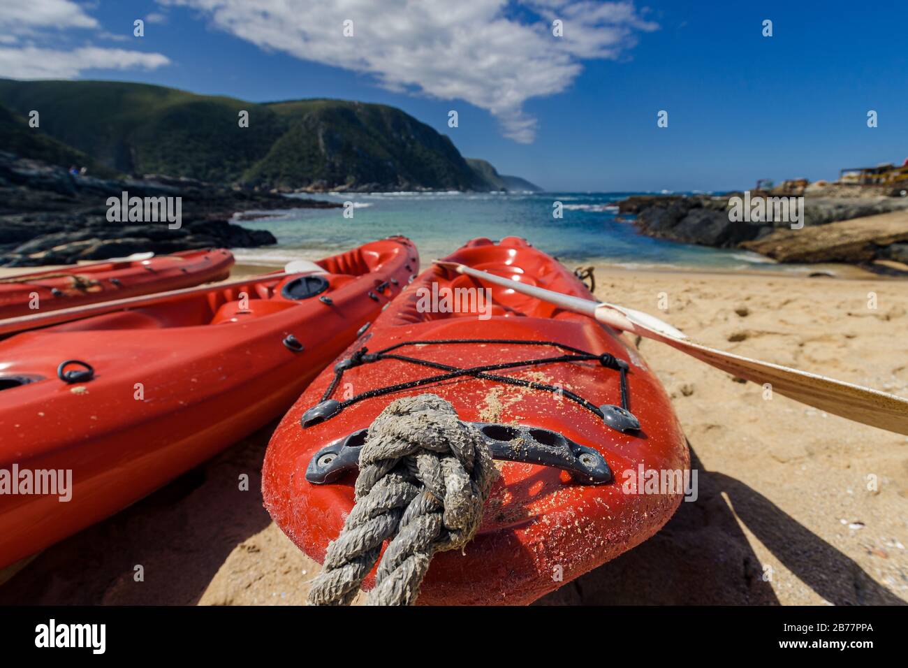 Close up of rope knot of red canoes on sandy beach,Storms river ...