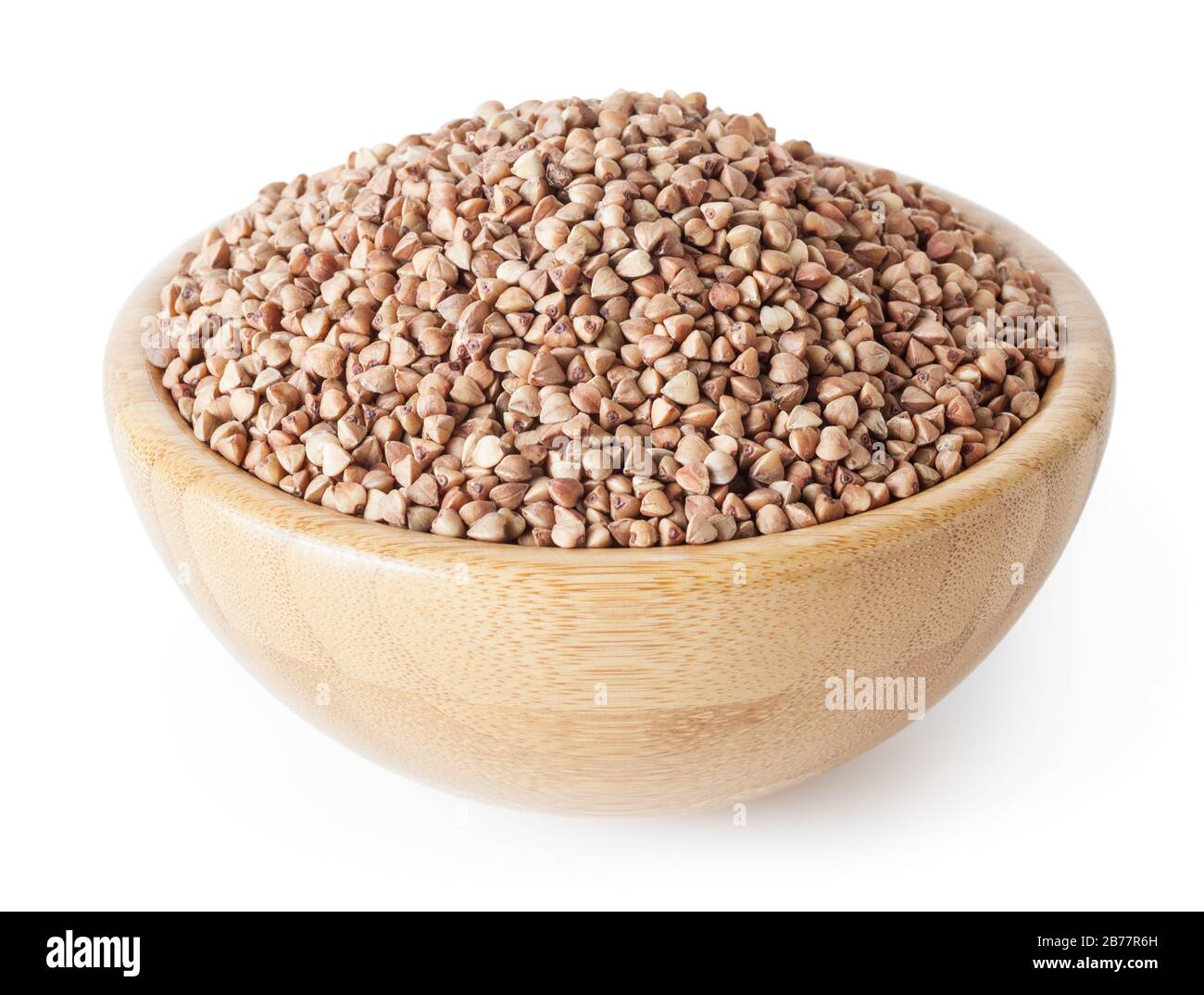 Roasted buckwheat grains in wooden bowl isolated on white background ...